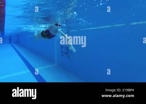 sportswoman swimmer in a tracksuit, in diving goggles, in a swimming ...