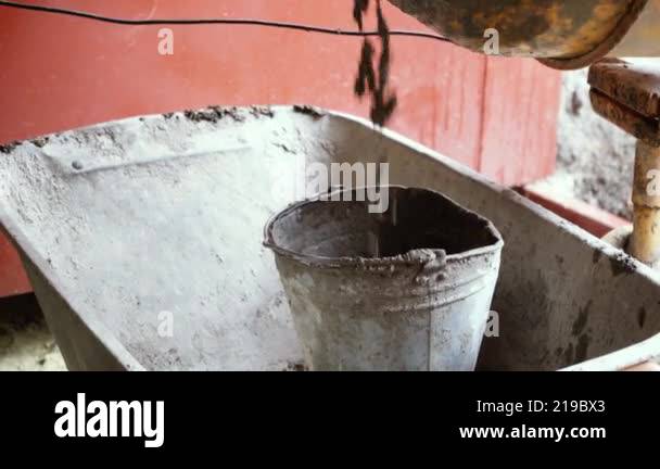 The concrete mixer mixes the building mix and pours it into a bucket ...