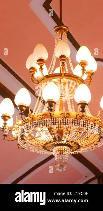Vertical, Elegant chandelier against pink backdrop. Sparkling ...