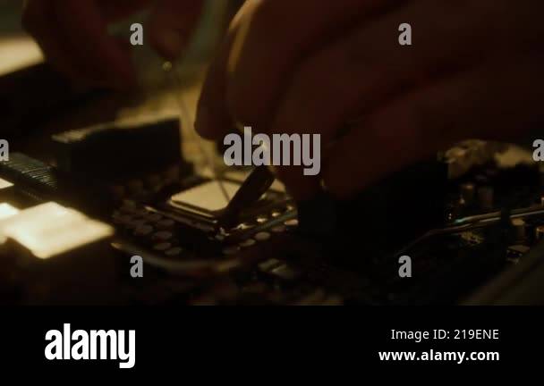 Close-up shot of hands of unrecognizable person removing CPU from ...