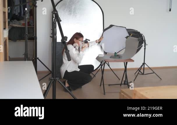 Female photographer taking photo of objects on background in photo ...