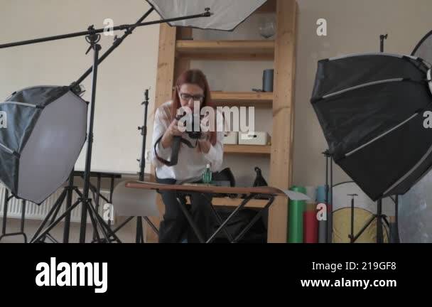 Female photographer taking photo of objects on background in photo ...