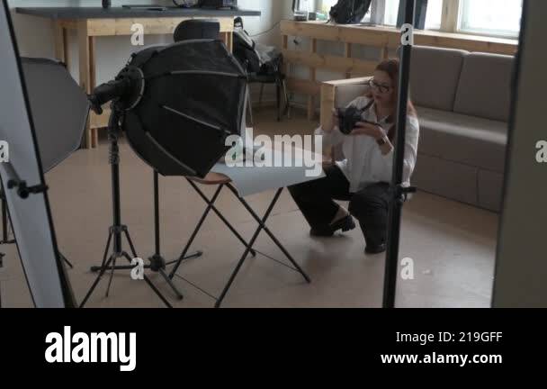Female photographer taking photo of objects on background in photo ...