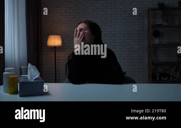 Depressed woman in dark apartment. Woman suffering mental health issues ...