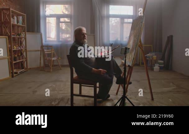 Day in life of senior man. Elder man spending his free time with hobby ...