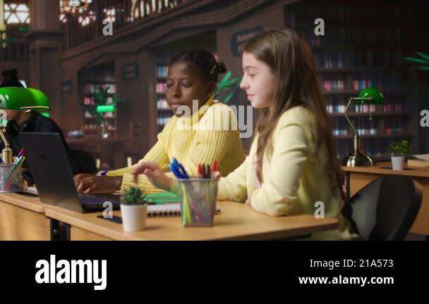 Primary school pupils in a library discuss during an online seminar ...