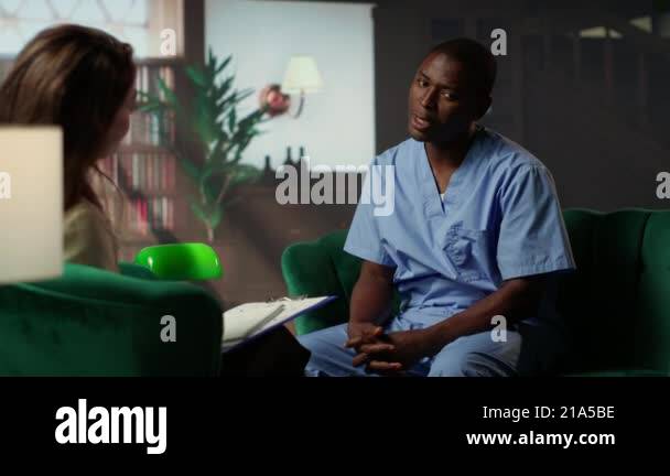 African american medical assistant in scrubs reflects on loss and burnout, sharing his feelings ...