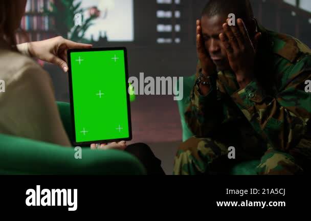 Black army soldier crying at therapy session next to chroma key screen ...