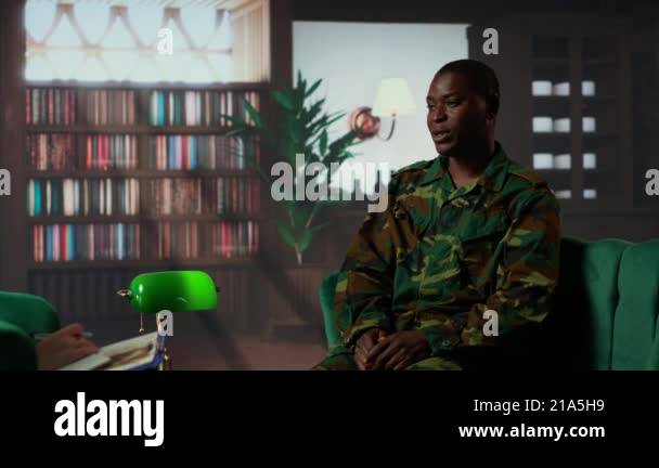 Camouflaged black army trooper meeting with a psychologist at therapy ...
