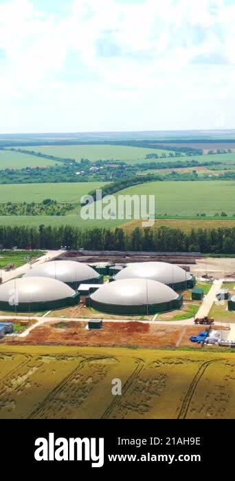 Modern farm for biogas production on field. Innovative factory among ...