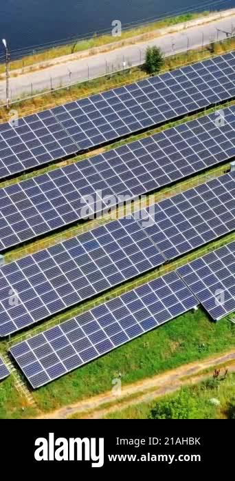 Solar power station near river at sunny day. Some solar panels in rows ...