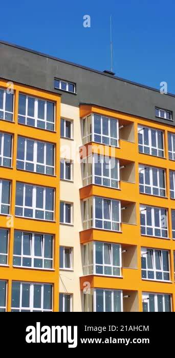 Modern high-rise building against blue sky. Newly built apartment ...