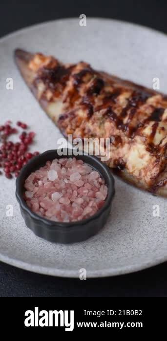 Grilled mackerel fillets with cheese, salt, spices and herbs on dark ...