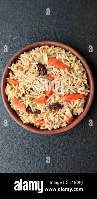 Delicious fresh pilaf with rice, carrots, meat, onions, spices and ...