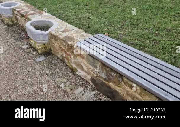 bent sandstone walls made of stone blocks serve as design elements ...