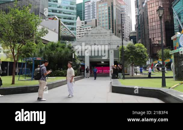 Singapore- 11 Dec 2024: View of Raffles place subway entrance building ...