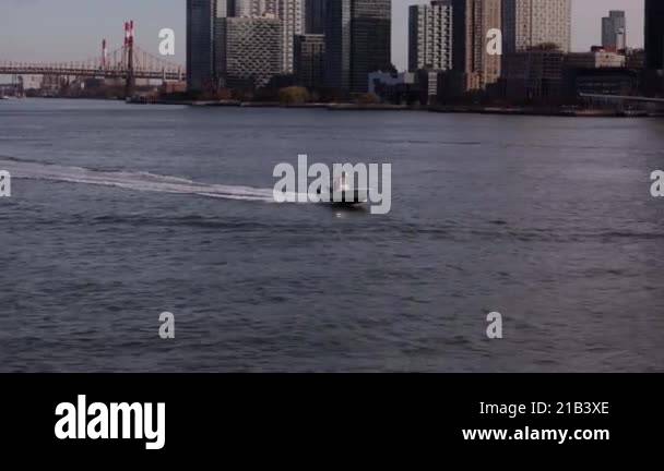 Coast guard boat navigates East River, passing Roosevelt Island between ...