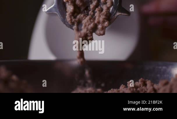 A detailed view of the meat grinding process for meal preparation Stock ...