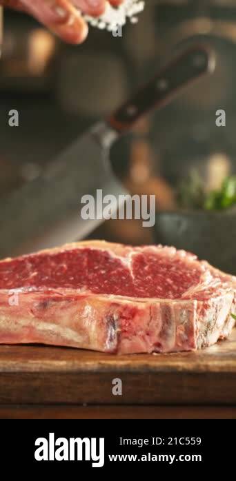 Super Slow Motion of Flying Salt no Raw Beef Steak. Camera Placed on ...