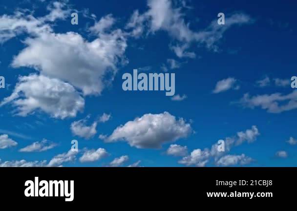 Sky timelapse. Moving clouds and sun. White fluffy clouds slowly float ...