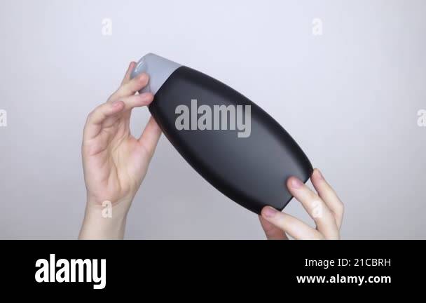 Female hands holding a can of shampoo, without any inscriptions or ...