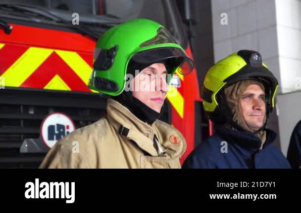 Portrait of male firefighters in helmets and protective uniforms ...