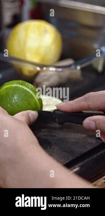 Slicing lime for fresh citrus preparation, symbolizing vitality and ...