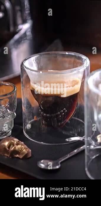 Steaming coffee in skull-shaped glass, evoking mystery and Halloween ...