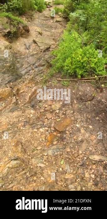 Upward shot of Bayehon waterfall on Ourthe river, rocky slope and wild ...
