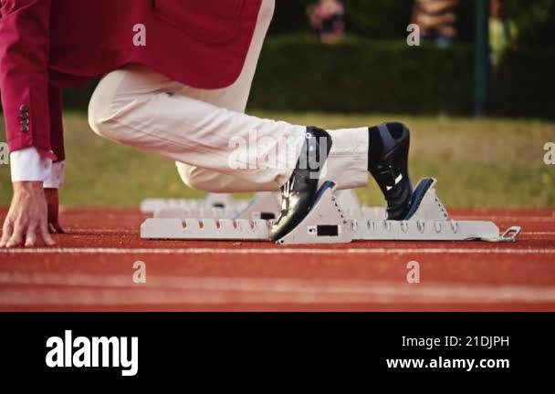 Businessman preparing to run on the competition athletics running race ...