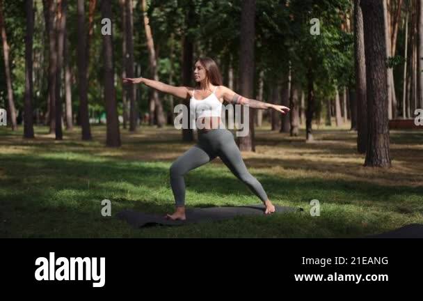 A young woman finds joy in practicing various yoga poses amidst the ...