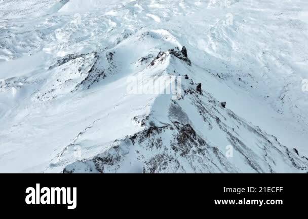 The steep peaks are covered in ice and snow, and the valleys are ...