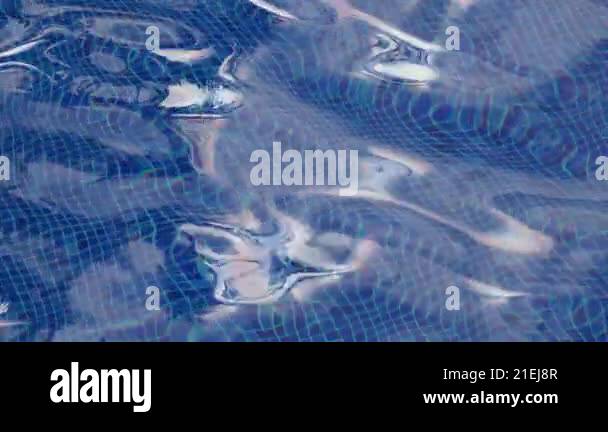 The serene water surface is displaying intricate geometric patterns ...