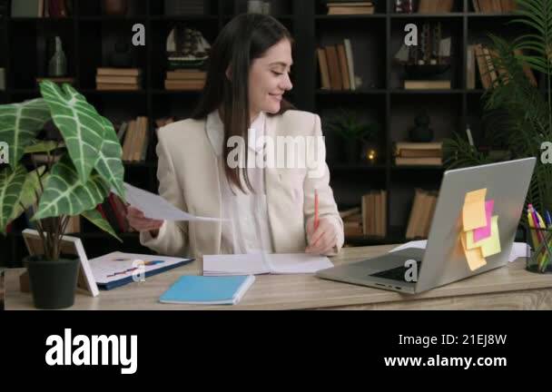 Cheerful elementary school teacher creates interesting tasks for ...