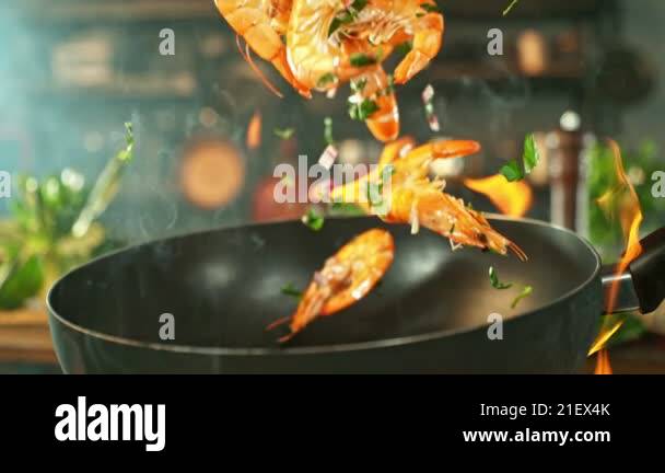 Super Slow Motion of Flying Asian Meal with Vegetable and Prawns into Wok Pan. Filmed on High ...