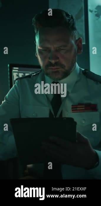 Medium vertical shot of busy middle-aged Caucasian male military ...