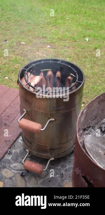 Close-Up of Vertical Smoker with Wooden Handles Cooking Hanging Bacon ...