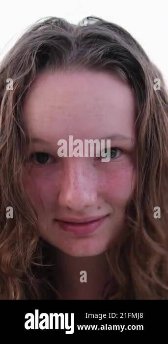 Relaxing on beach emotions of young girl burnt skin red cheeks wet hair ...