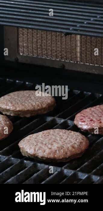 Cooking beef patties for burgers. Slow motion. Hamburger patties are ...
