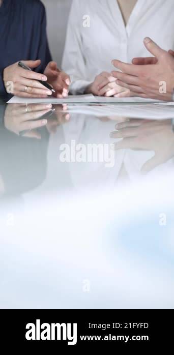 Business people or lawyers are reviewing contract terms during a ...