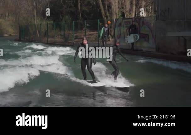 March 25, 2022. Munich, Germany. Surfers surfing an River Isar in ...