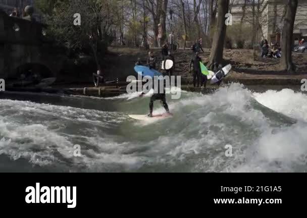 March 28, 2022. Munich, Germany. Eisbachwelle am Englischen Garten ...