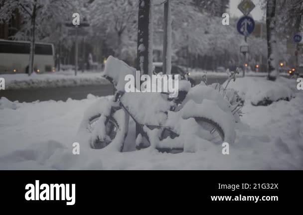 Munich, Germany. Snowfall in Muenchen. Snow covered bicycles in city ...
