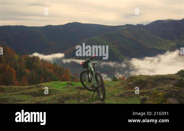 Electric bike stands on high mountain above clouds in autumn in ...