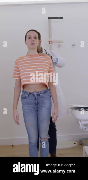 Professional healthcare worker performing detailed posture assessment ...
