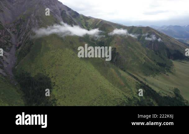 Large mountains covered with green grass and rocks. Aerial view of the ...
