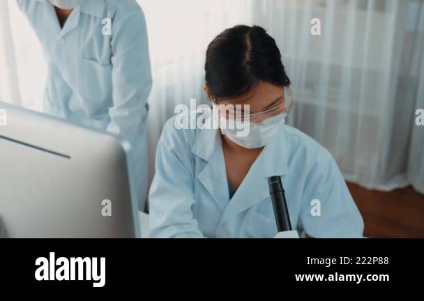 Laboratory chemistry researcher develop new medicine or cure using microscope, laptop ...