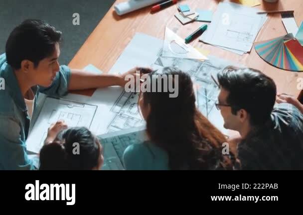 Top view of skilled civil engineer team writing at blueprint and ...