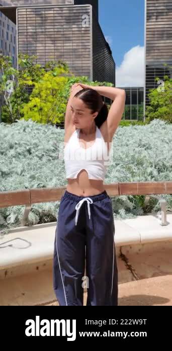 Female dancer warming up arm muscles with focused flexibility training ...