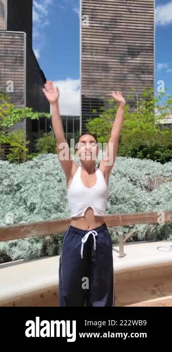 Graceful dancer executes a fluid arm movement in an urban setting ...